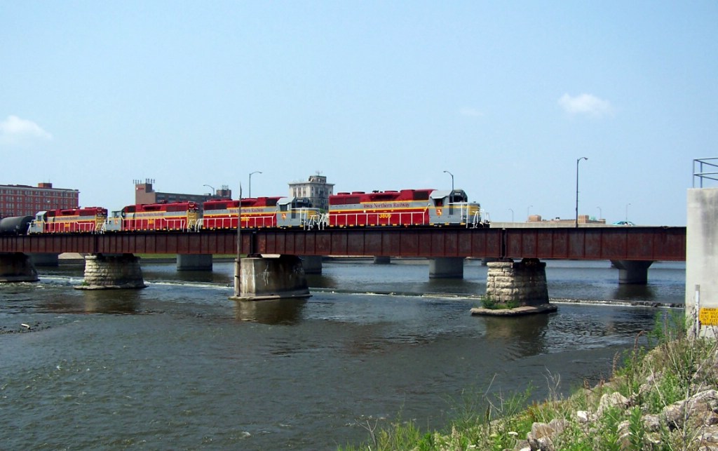 IANR 3806 leads a cut of cars northbound across the ex-CGW bridge
